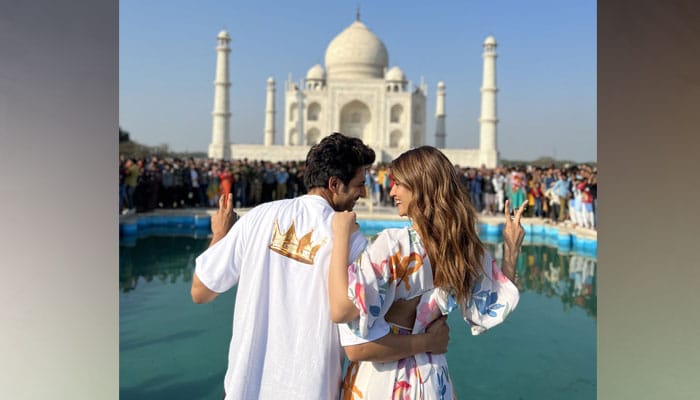 Kartik Aaryan poses with 'Shehzada' co-star Kriti Sanon